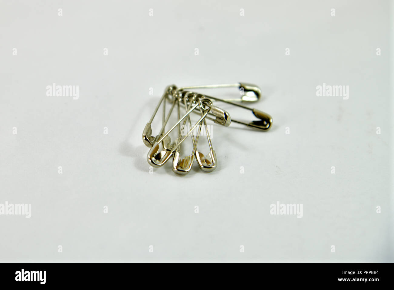 Safety pin isolated on white background Stock Photo - Alamy