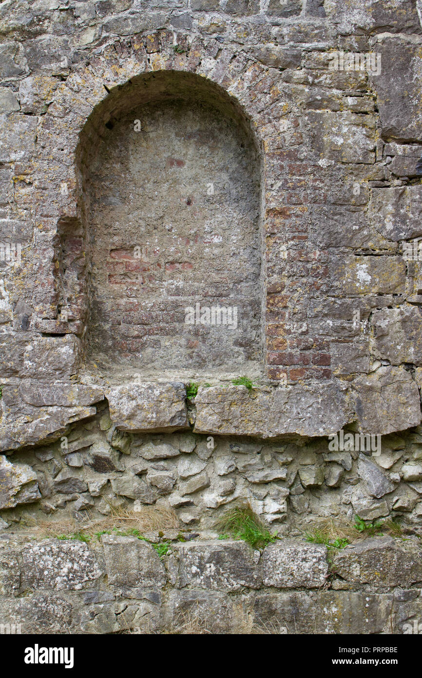 View of a bricked-in arched stone window in a medieval castle ruin in ...