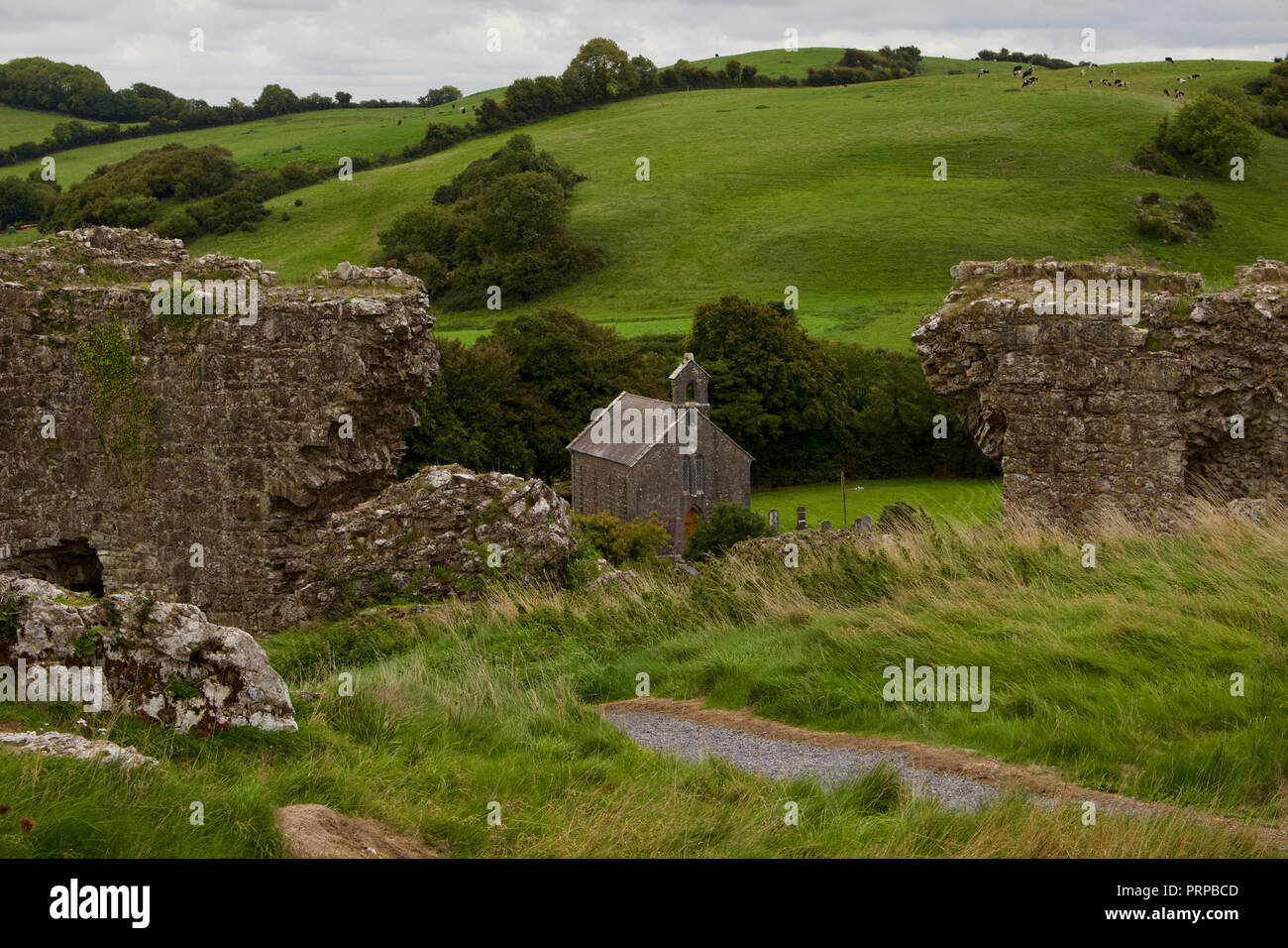 View of a church and countryside behind medieval castle ruins in ...