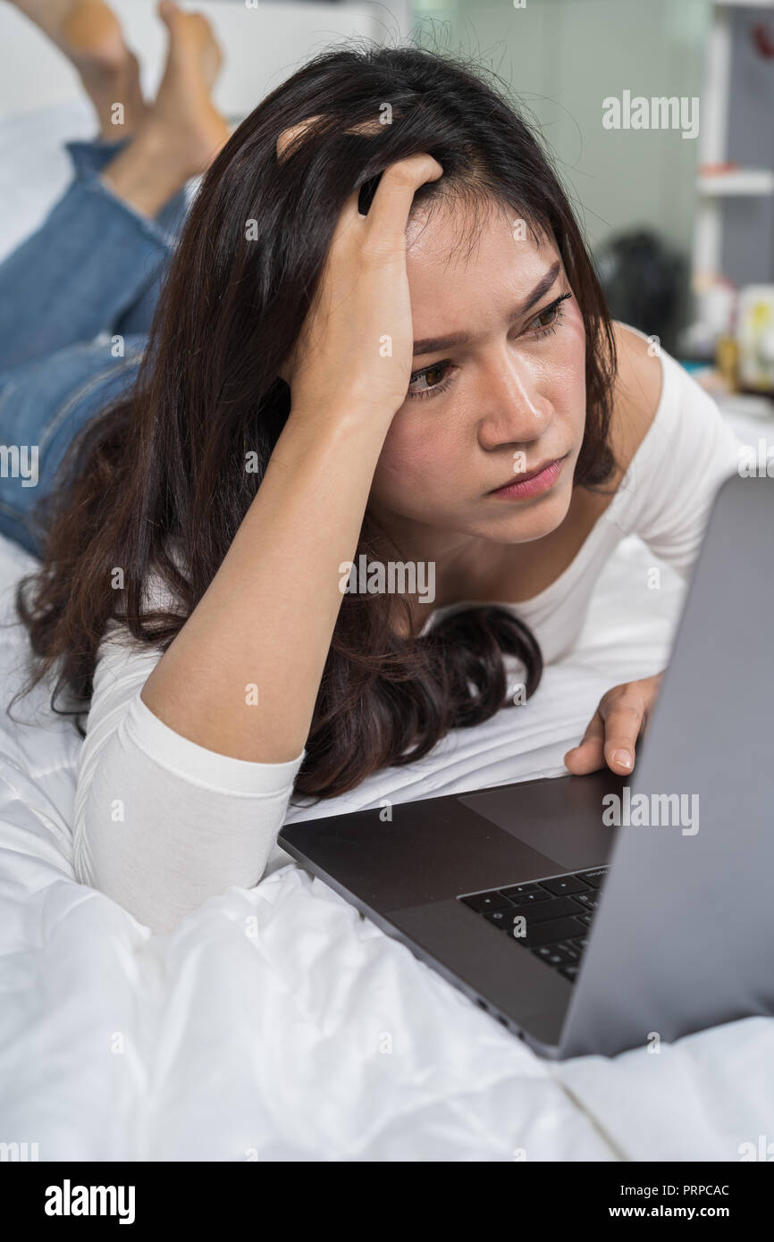 Depressed woman computer bed hi-res stock photography and images - Alamy