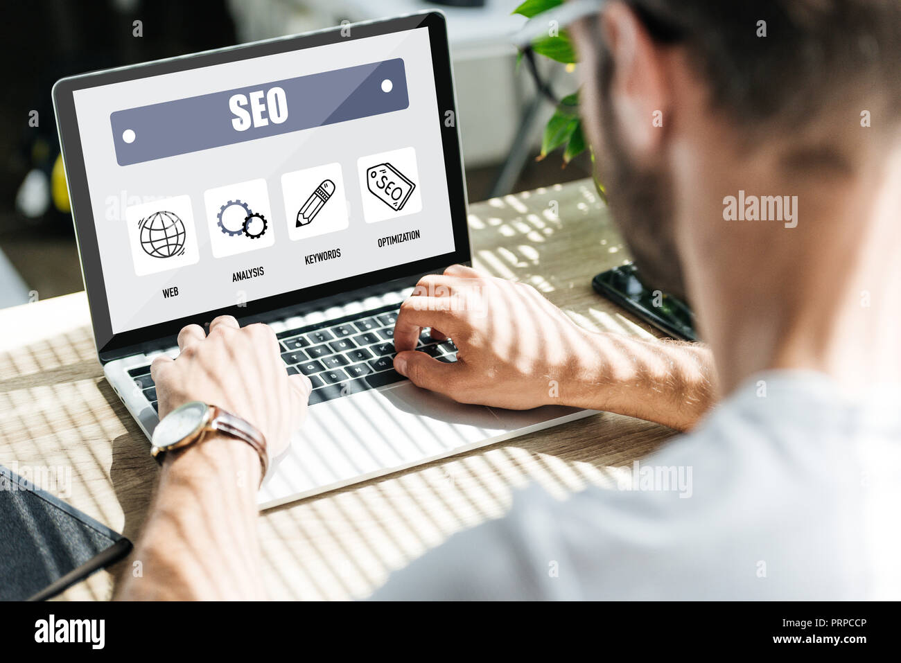 back view of developer using laptop with SEO icons Stock Photo - Alamy