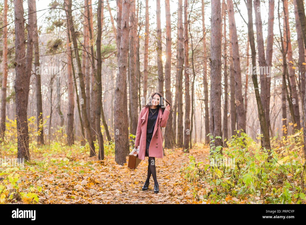 Portrait of beautiful young woman walking outdoors in autumn Stock ...