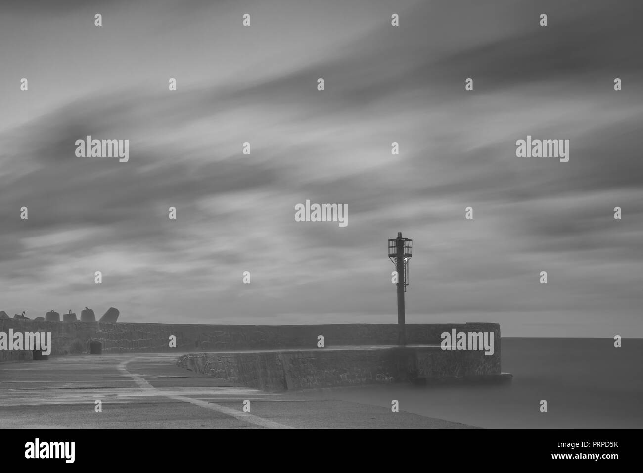 Long exposure coastal photography - clouds, sea and pier Stock Photo ...