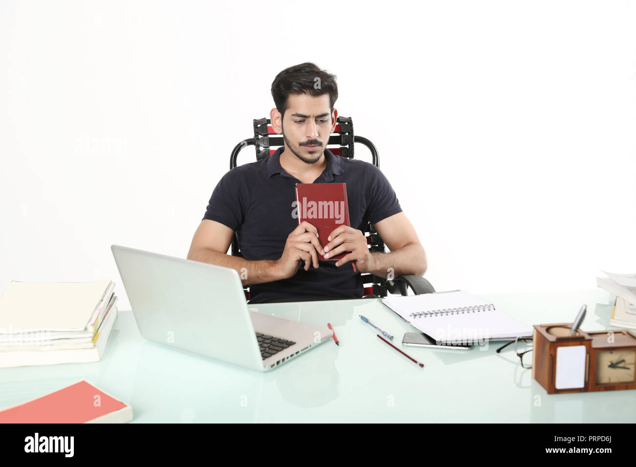 Young boy is holding diary in both hand and thinking about business in ...