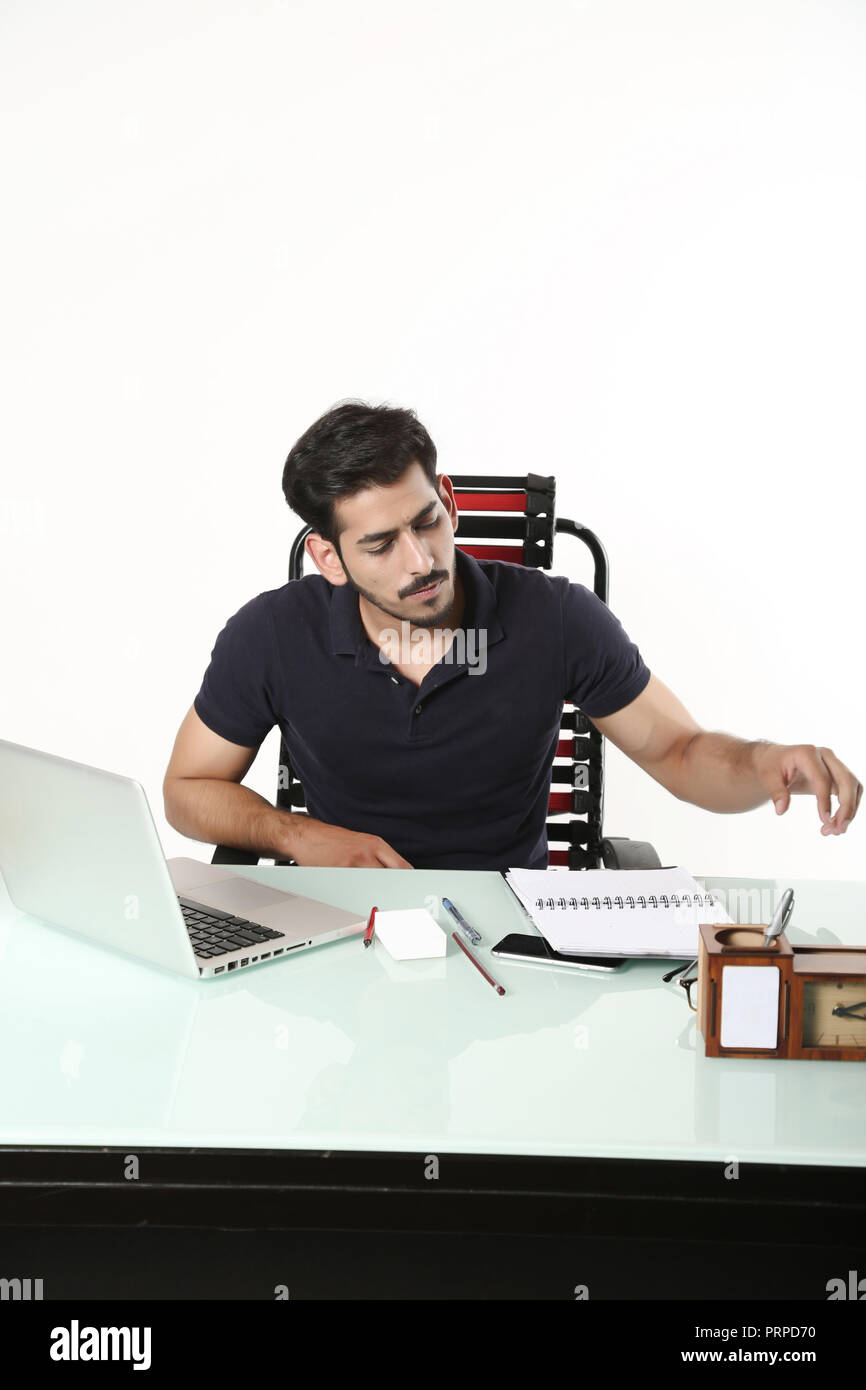 Man is trying pen pick up in hand sitting on the chair in the cabin ...