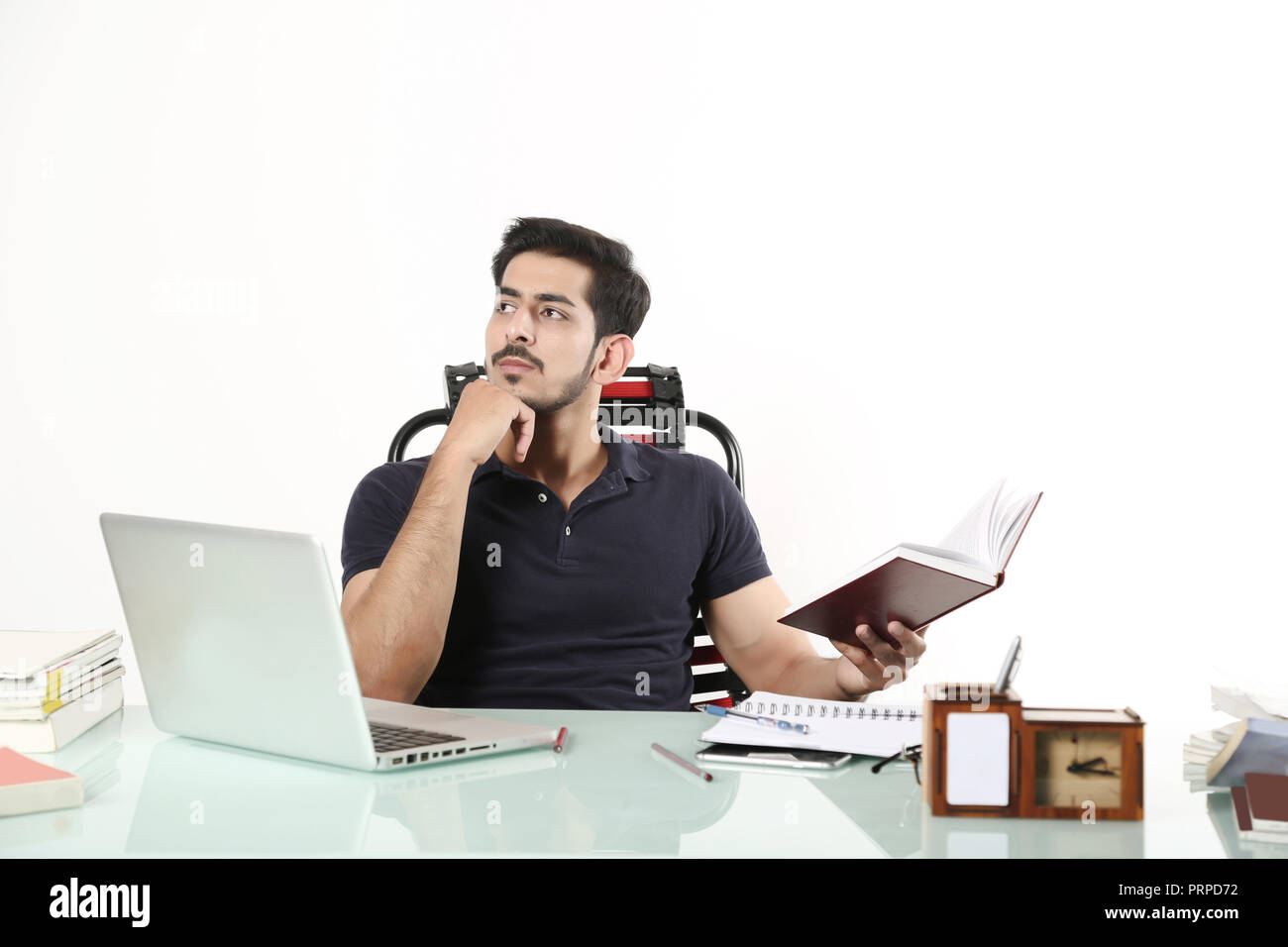 Young boy is holding open diary in hand with giving pose in the cabin ...