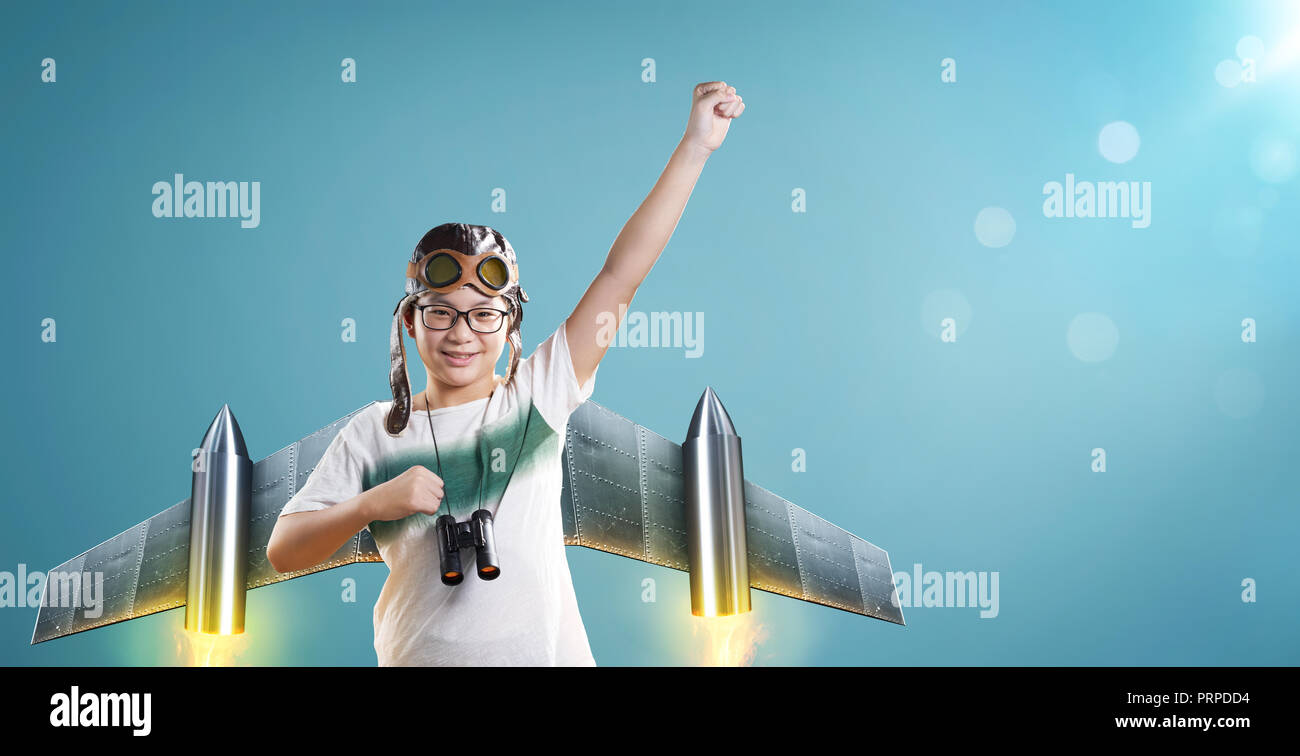 Happy asian child playing with toy rocket and dreaming of becoming a ...