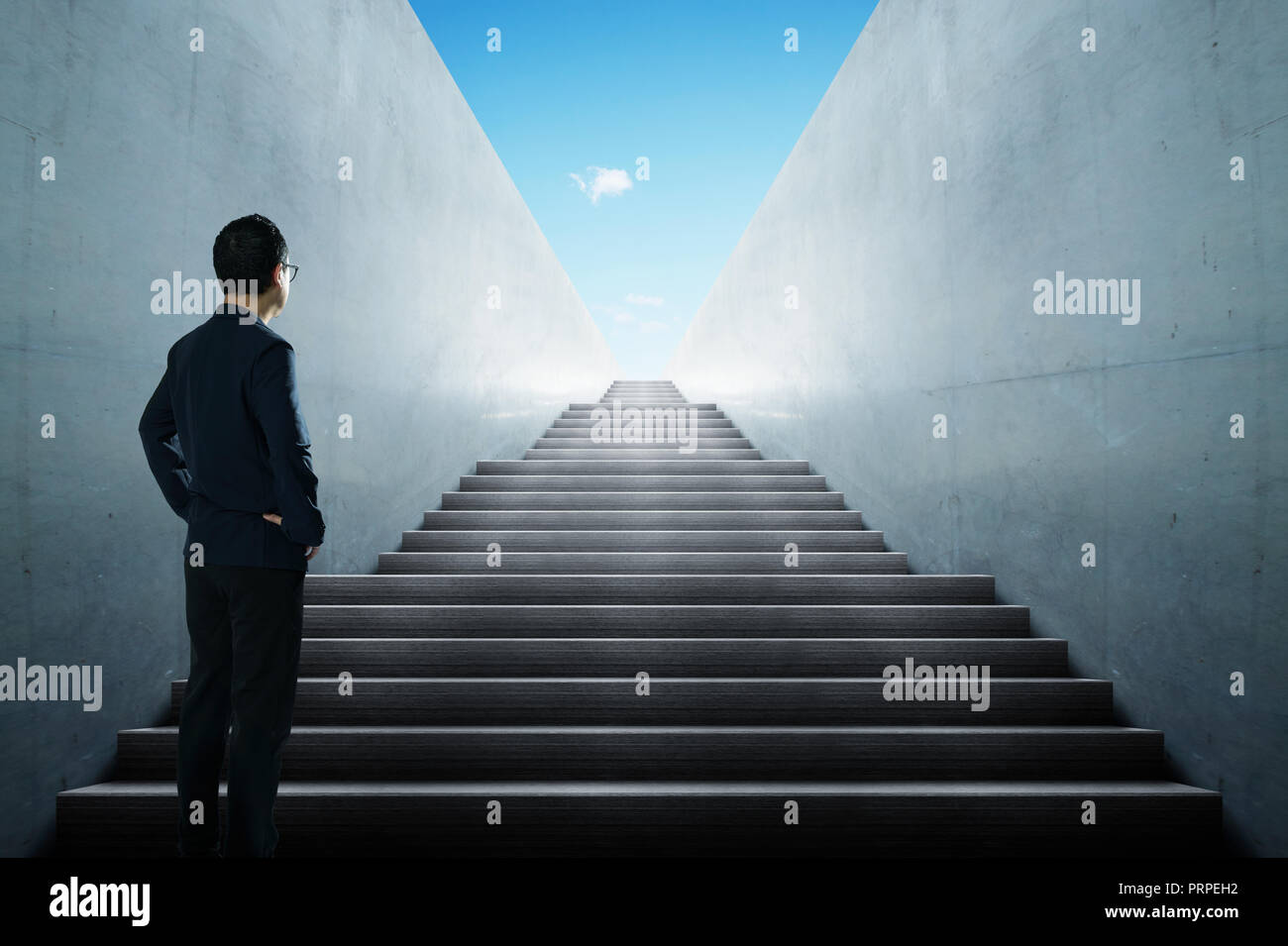 Businessman looking and thinking front of a stair infinty view Stock ...