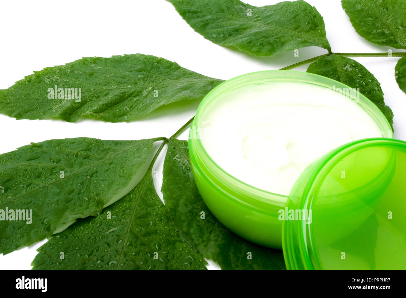 face cream with green leaf on white background Stock Photo - Alamy