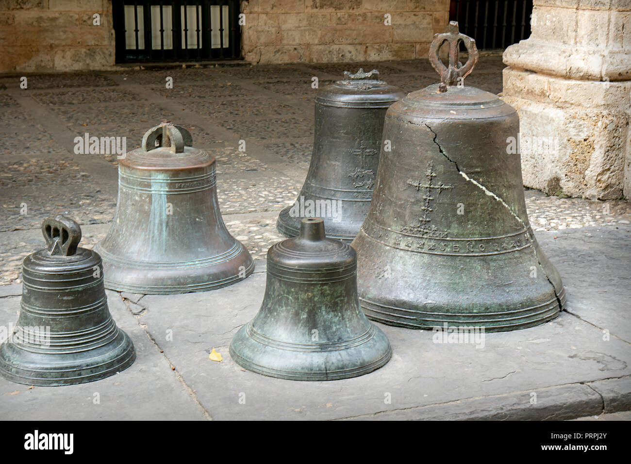 Four old church bells on the .street. Biggest one is cracked Stock ...