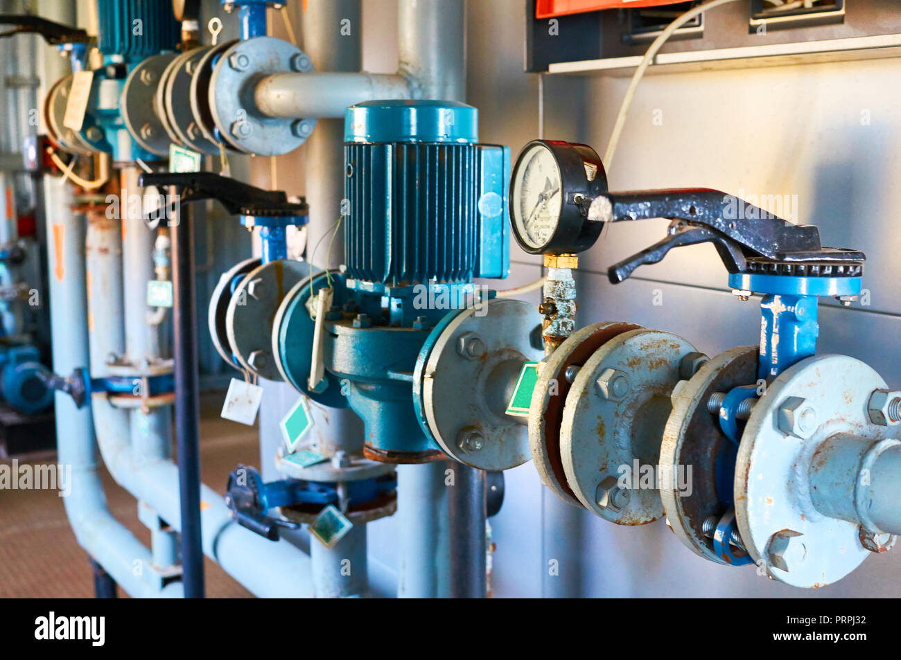 Old blue electric motor to the pump, valve and pressure gauge on the ...