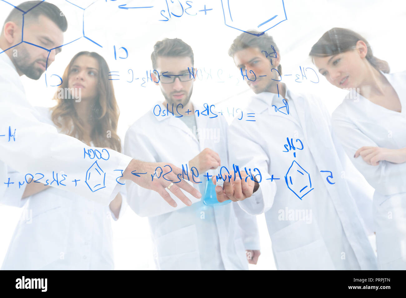view through the transparent Board. a group of scientists analyze ...
