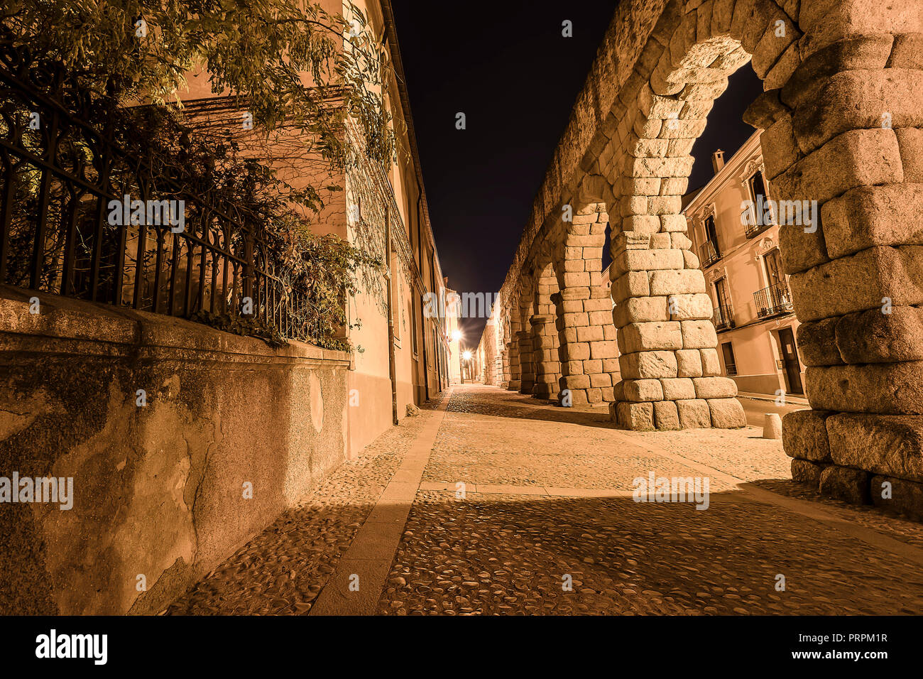 View of starting side of Segovia roman aqueduct at night with the only ...