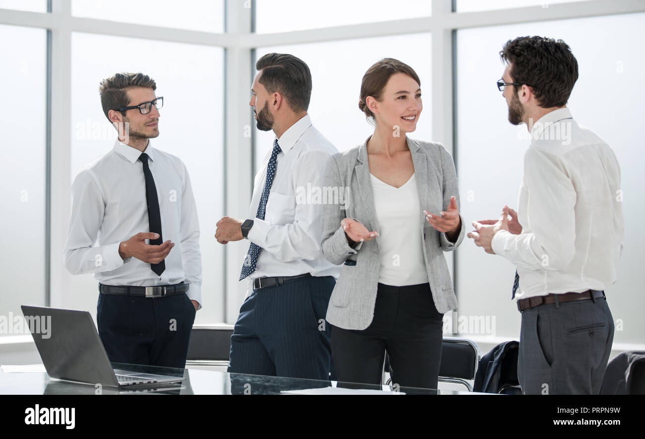 company employees discussing in the workplace Stock Photo - Alamy