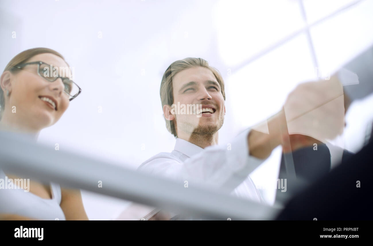 view from behind glass.handshake business people Stock Photo - Alamy