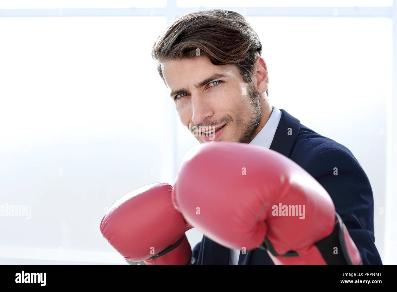 Businessman standing posture with boxing gloves Stock Photo - Alamy