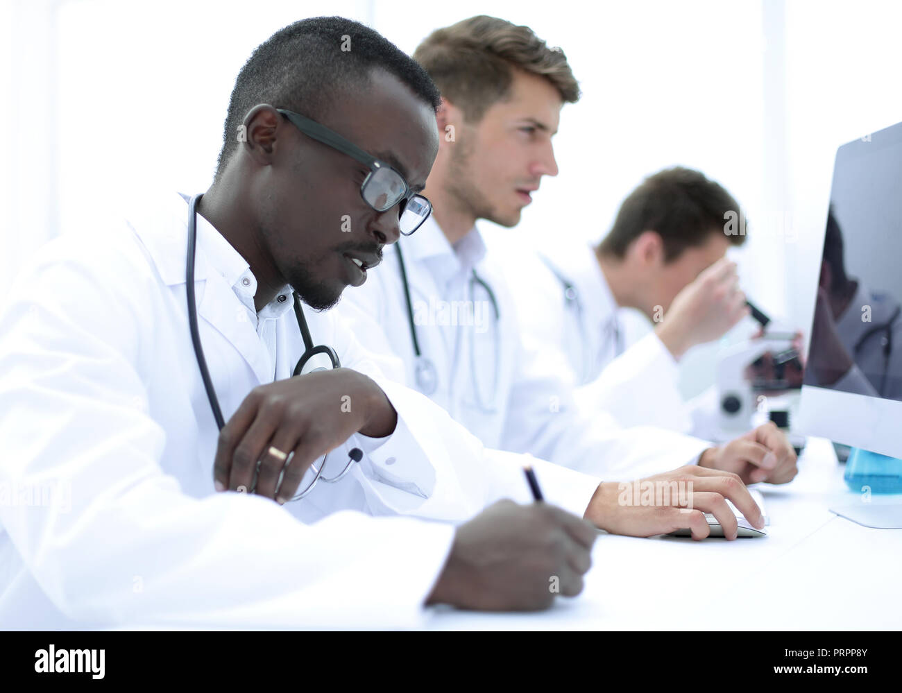 group of doctors sitting in the laboratory Stock Photo - Alamy