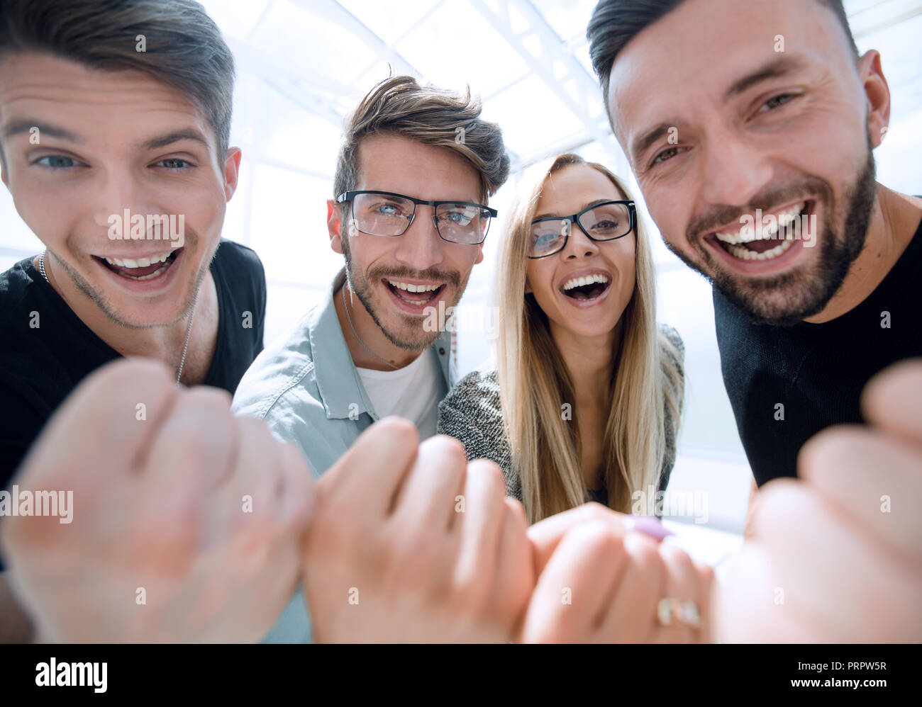 Friends celebrate the victory in the office Stock Photo - Alamy