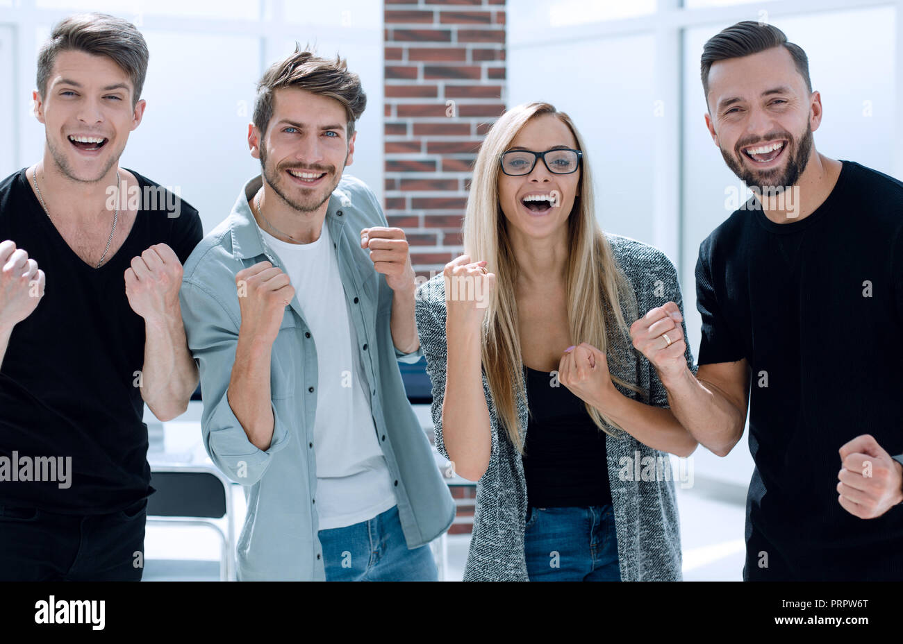 portrait of youth guys victoriously raising their fists up and r Stock ...