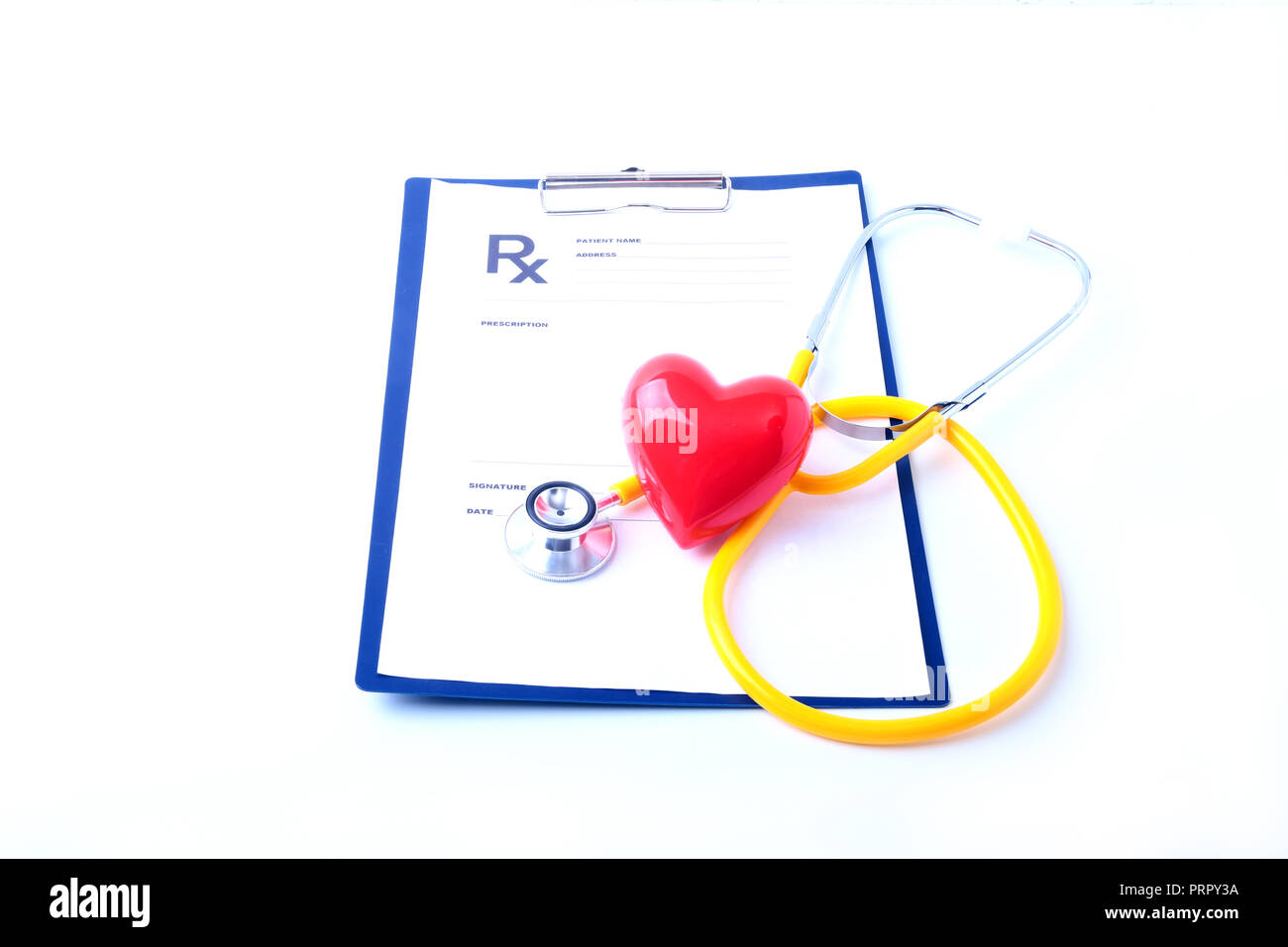 Closeup of medical stethoscope on a rx prescription, red heart isolated ...