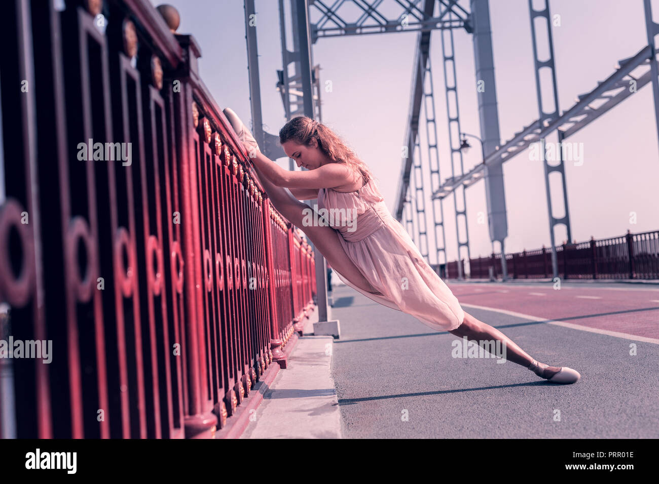 Nice beautiful woman putting the leg on the parapet Stock Photo - Alamy