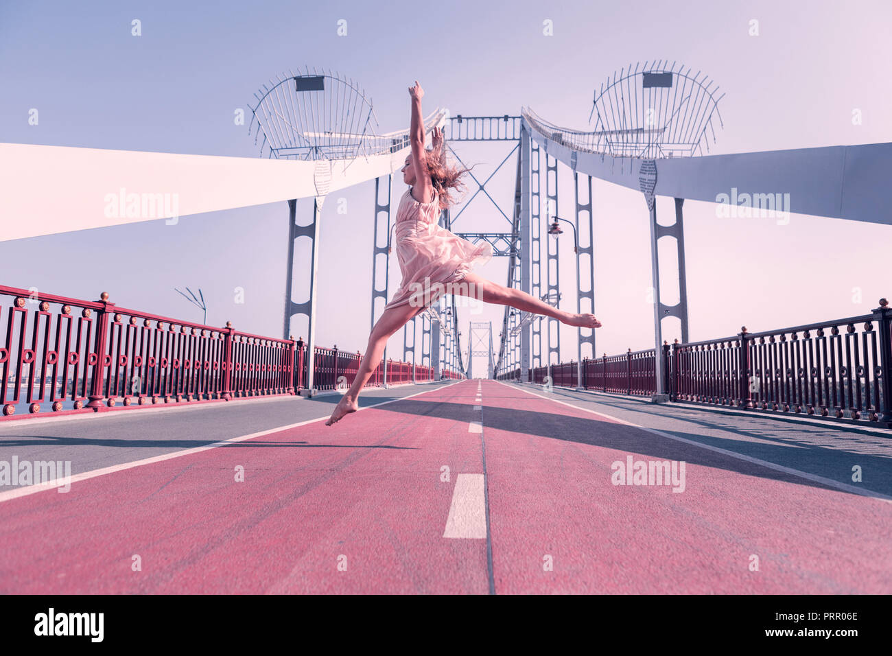 Nice skilled ballerina doing splits in the air Stock Photo - Alamy