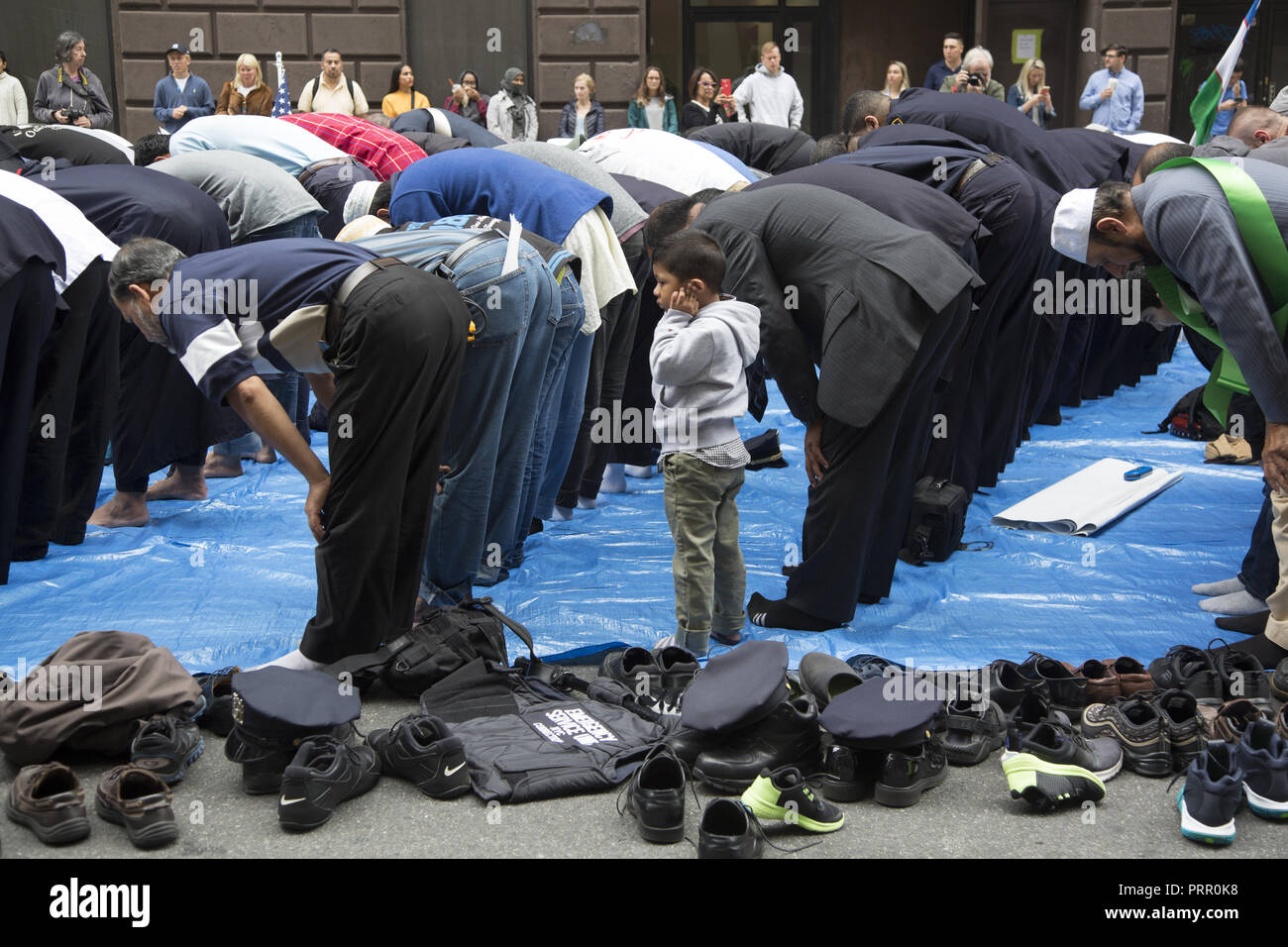 Diverse group of Muslim men pray on Madison Avenue before the annual ...