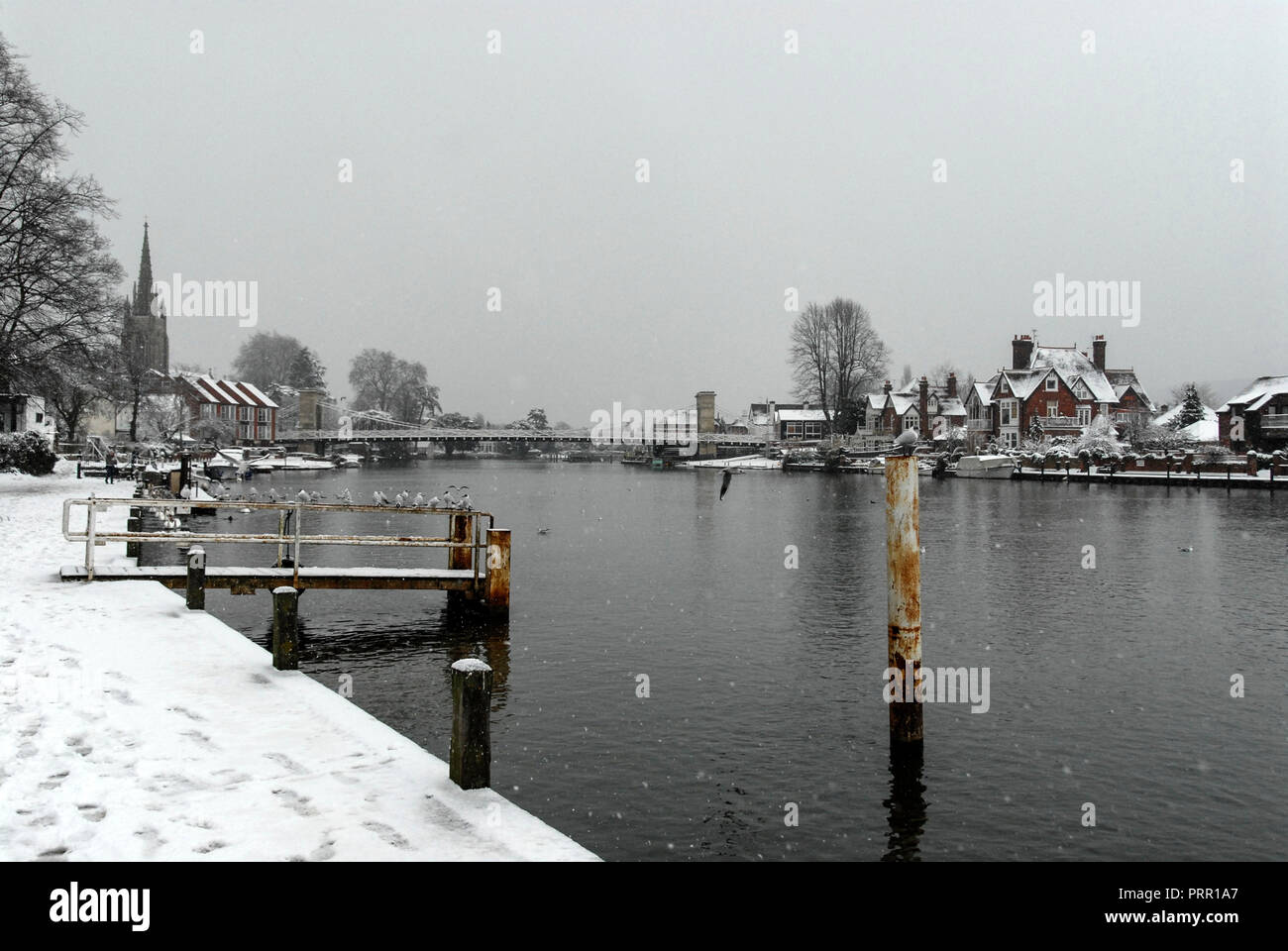 Snow falling on the river Thames at Marlow in Buckinghamshire, Britain ...