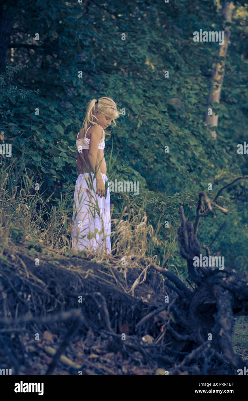 little girl walking in darkness in wild nature Stock Photo - Alamy