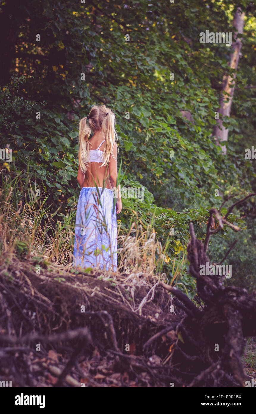 little girl walking in darkness in wild nature Stock Photo - Alamy