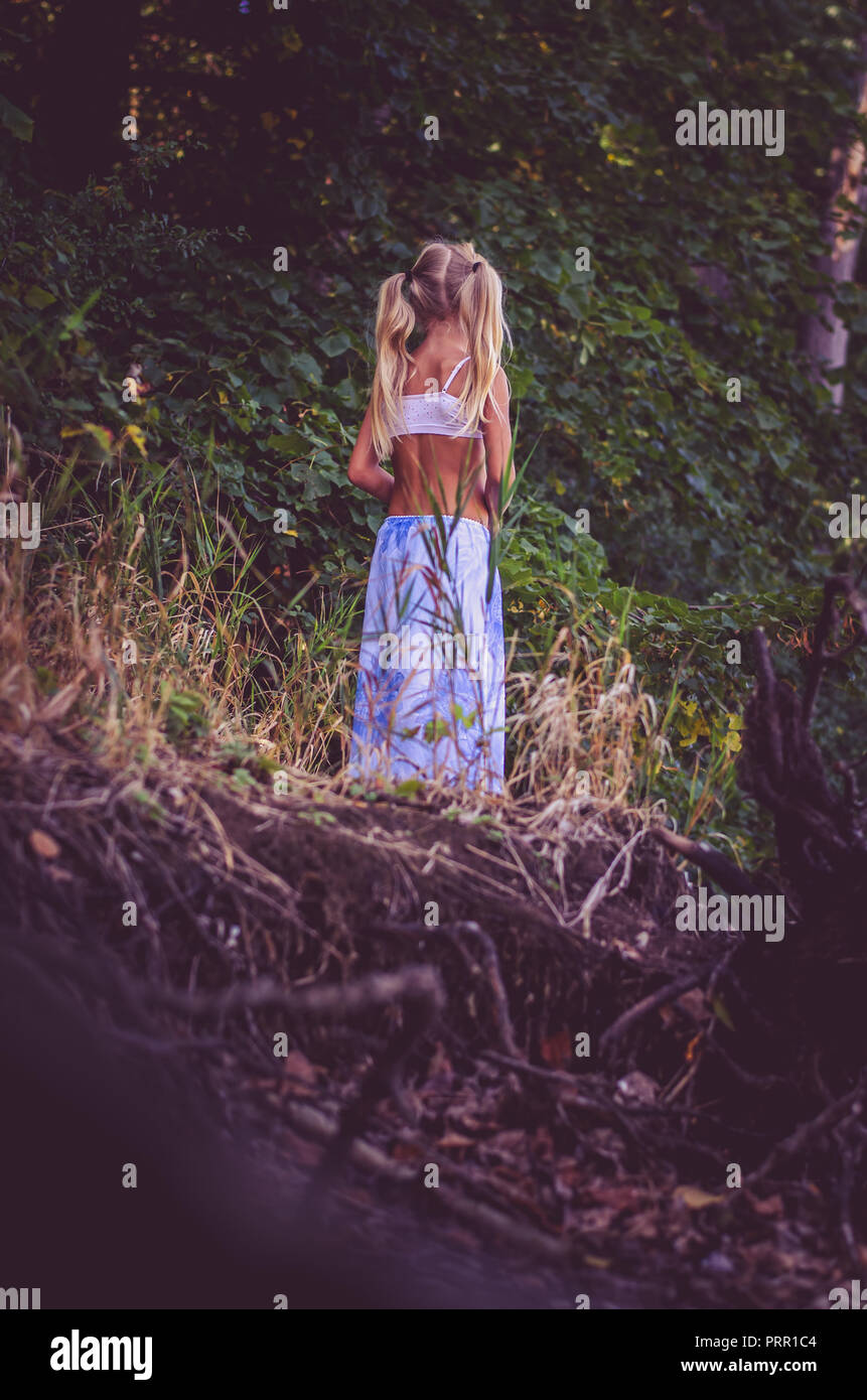 little girl walking in darkness in wild nature Stock Photo - Alamy