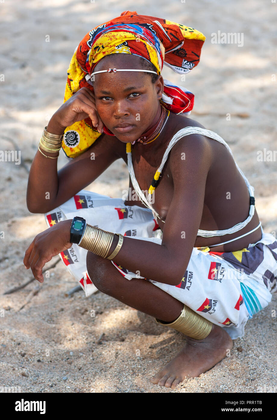 Portrait of a Mucubal tribe young woman wearing a colorful headwear ...