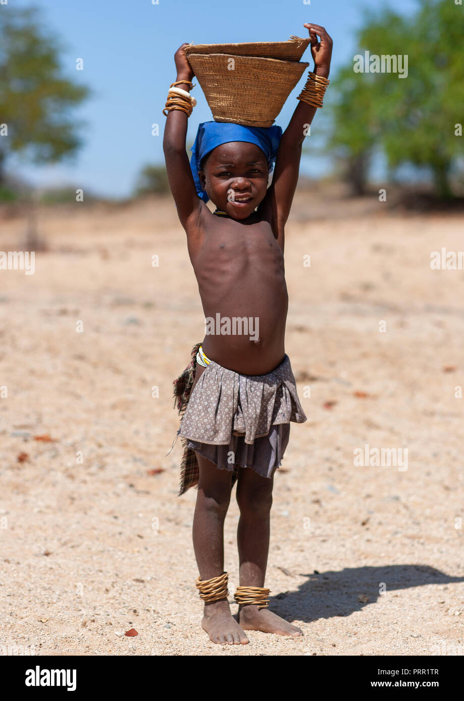 Mucubal tribe girl carrying a basket on head, Namibe Province, Virei ...