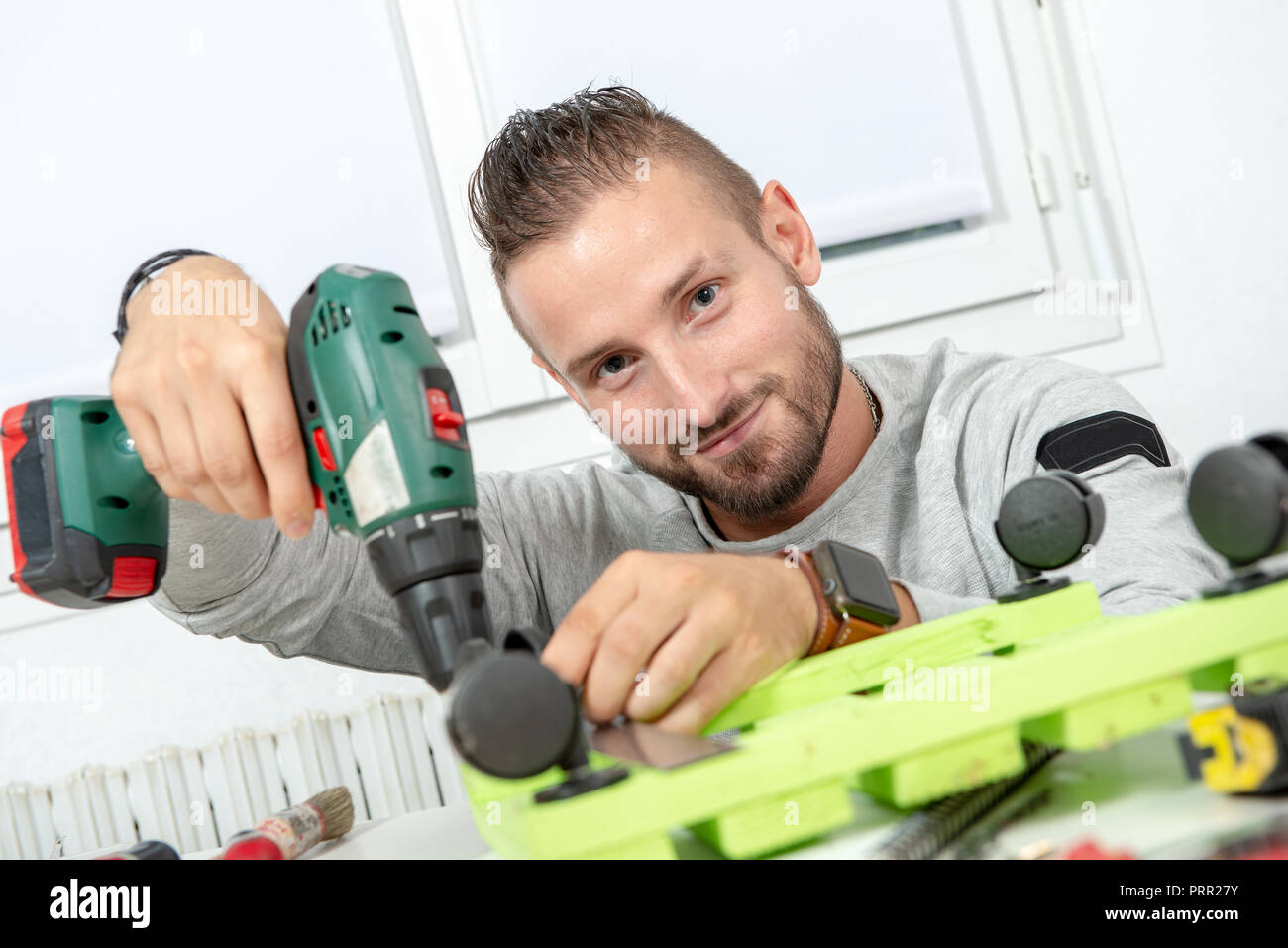 a young man DIY using electric drill Stock Photo - Alamy