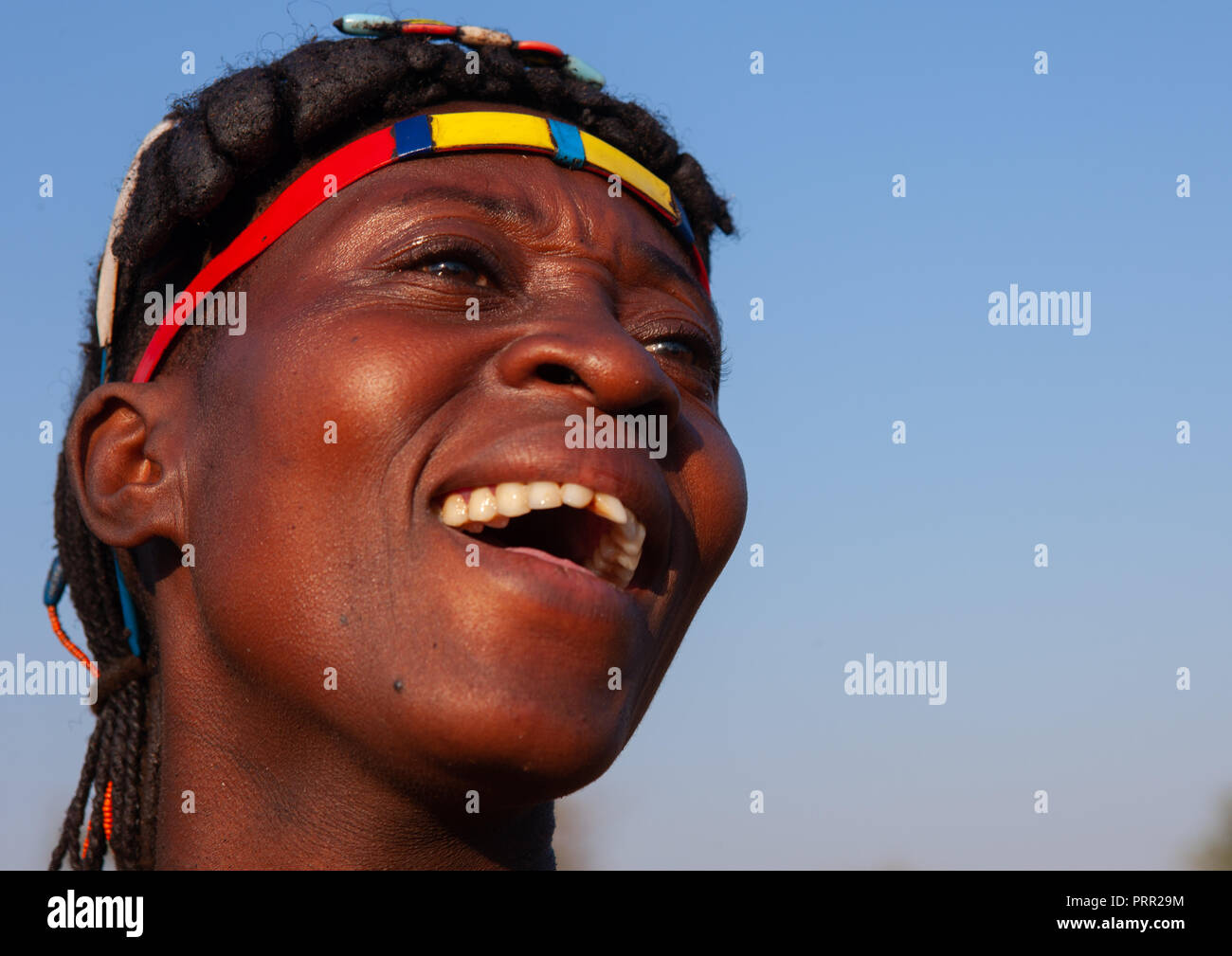 Portrait of a laughing Muhacaona tribe woman, Cunene Province, Oncocua ...