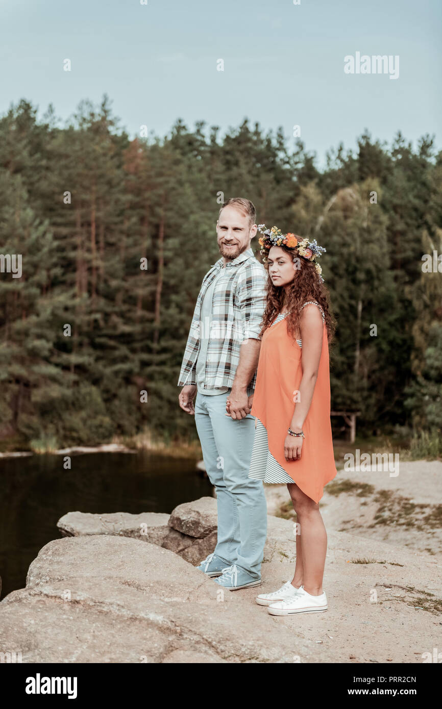 Beautiful dark-haired girlfriend wearing floral chaplet standing near ...