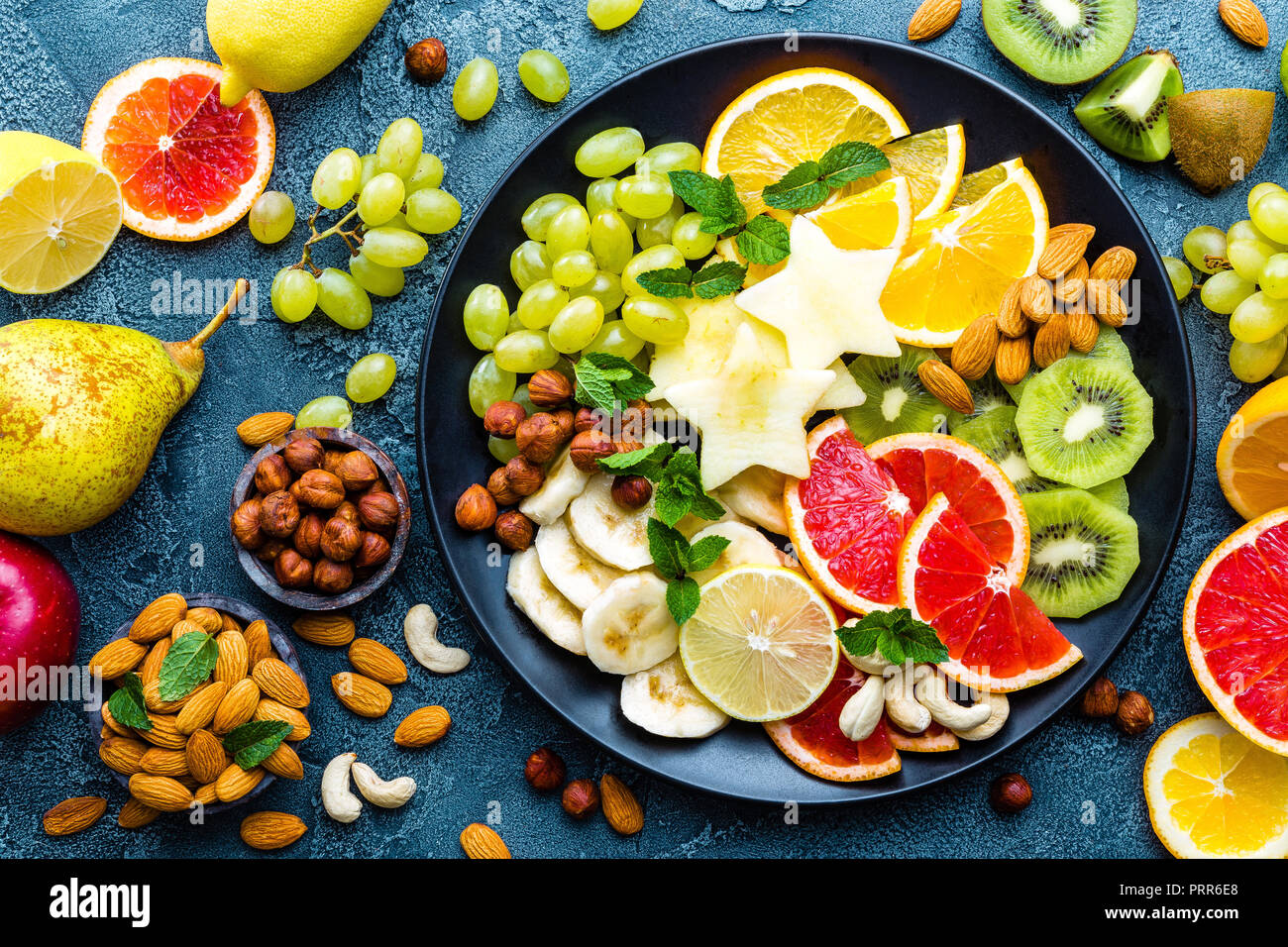 Healthy vegetarian bowl dish with fresh fruits and nuts. Plate with raw ...