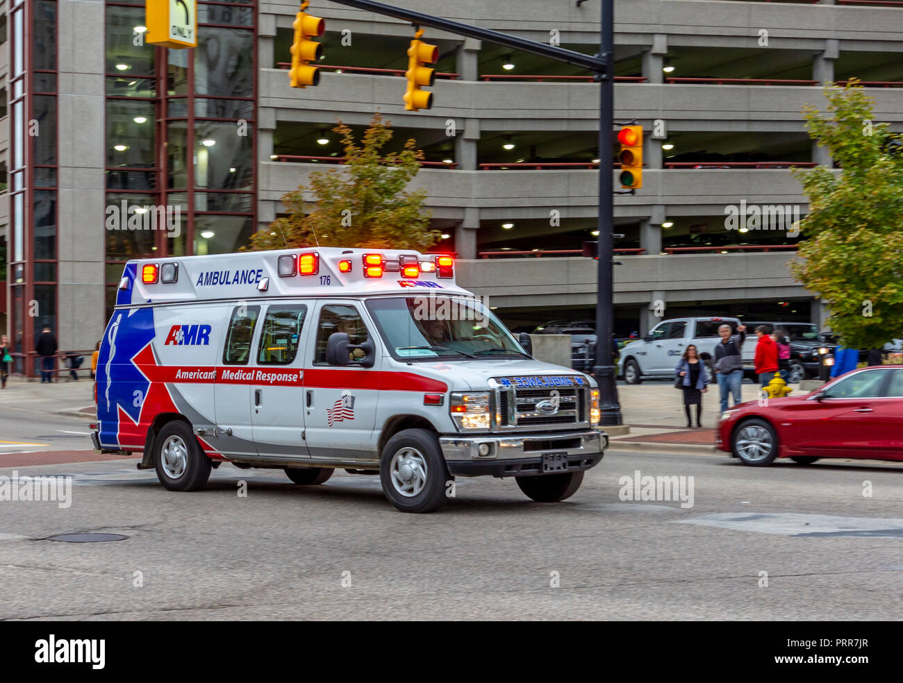 An AMR (American Medical Response) ambulance drives through an ...