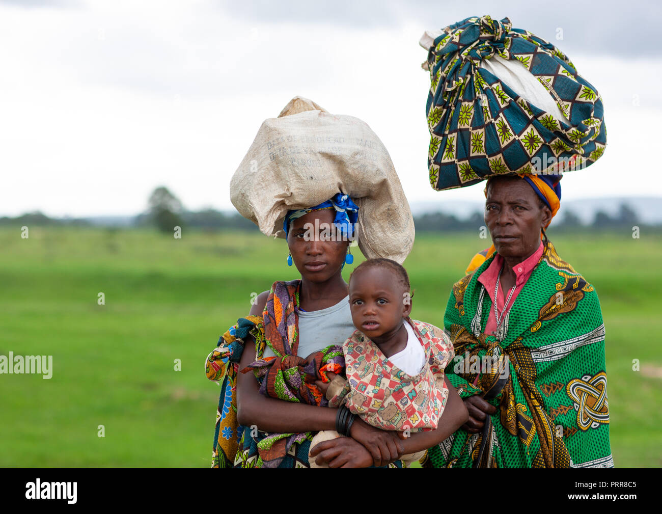 Women walking carrying sacks on head, Huila Province, Chibia, Angola ...
