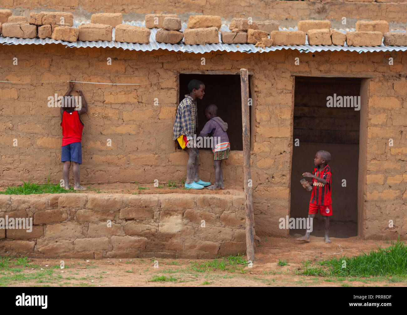 Angolan children playing in front of a house, Huila Province, Caconda ...