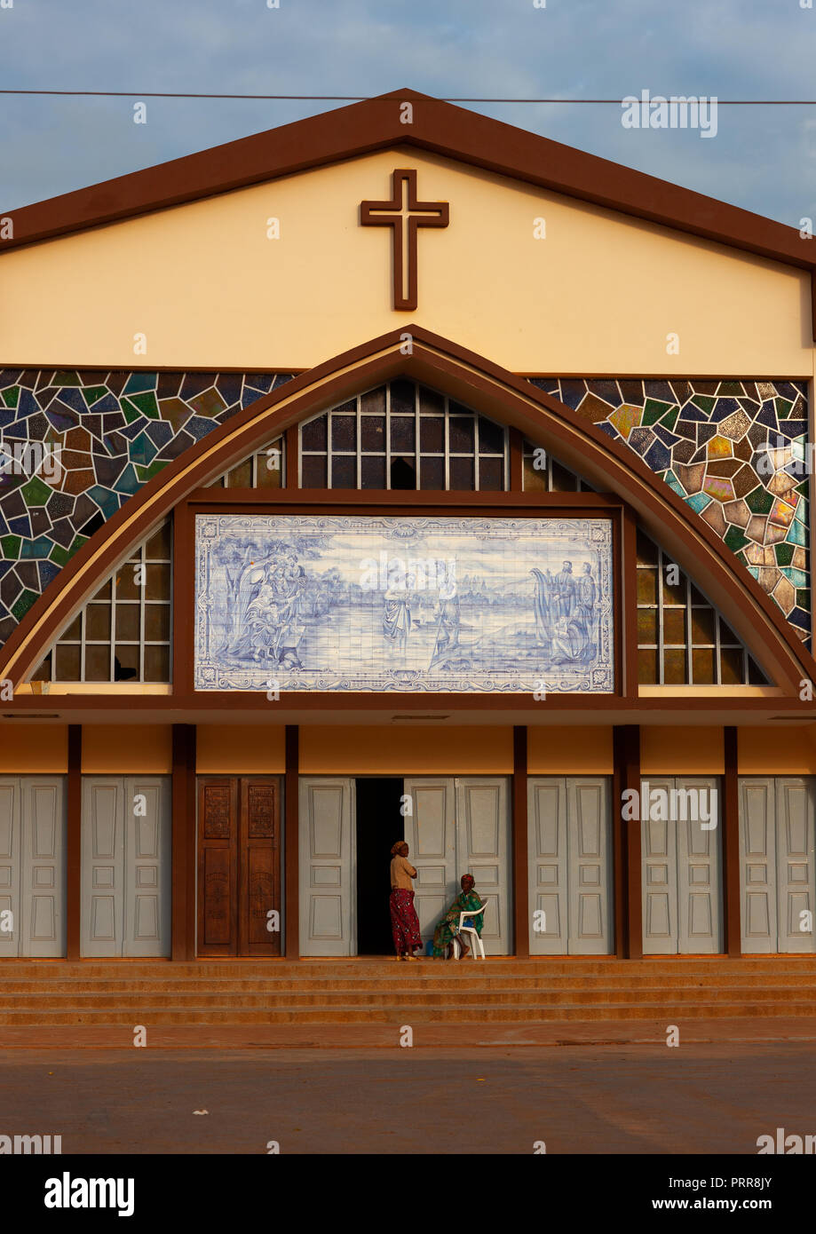 Angolan people sit in front of a church, Cuanza Norte, N'dalatando ...