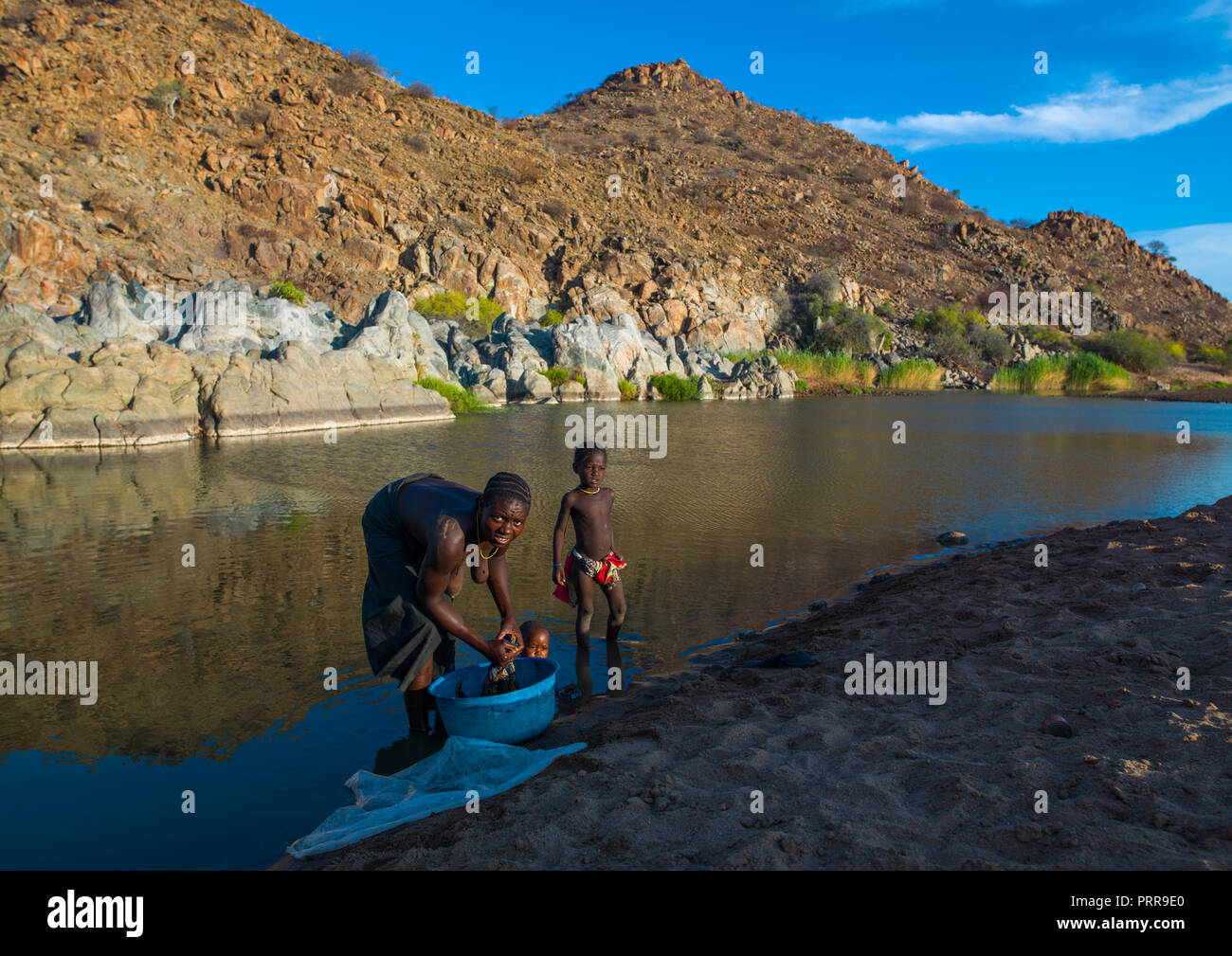 Angolan woman washing cloths in pediva hot springs, Namibe Province ...