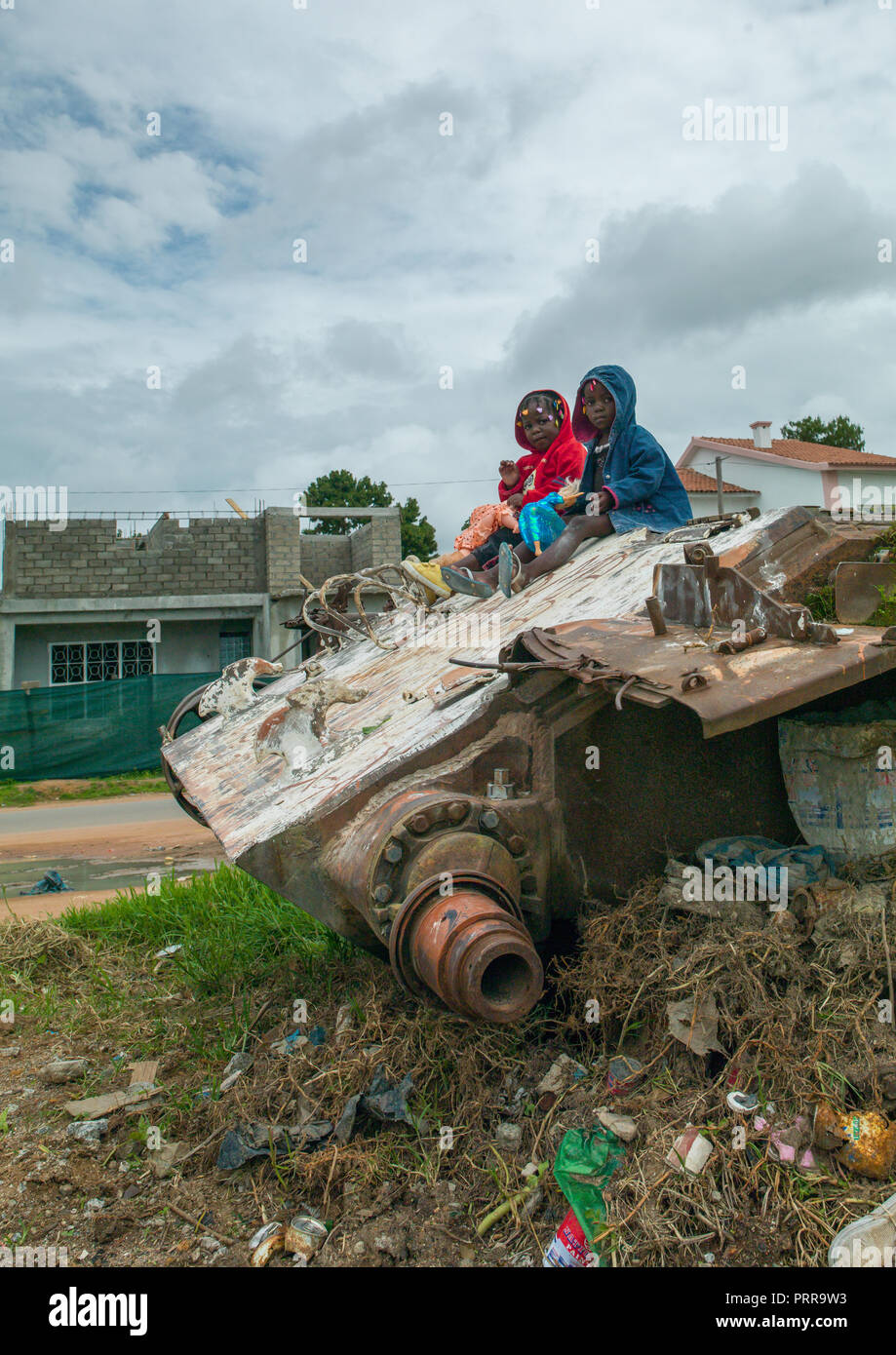 Angolan children playing on a tank wreck, Huambo Province, Huambo ...