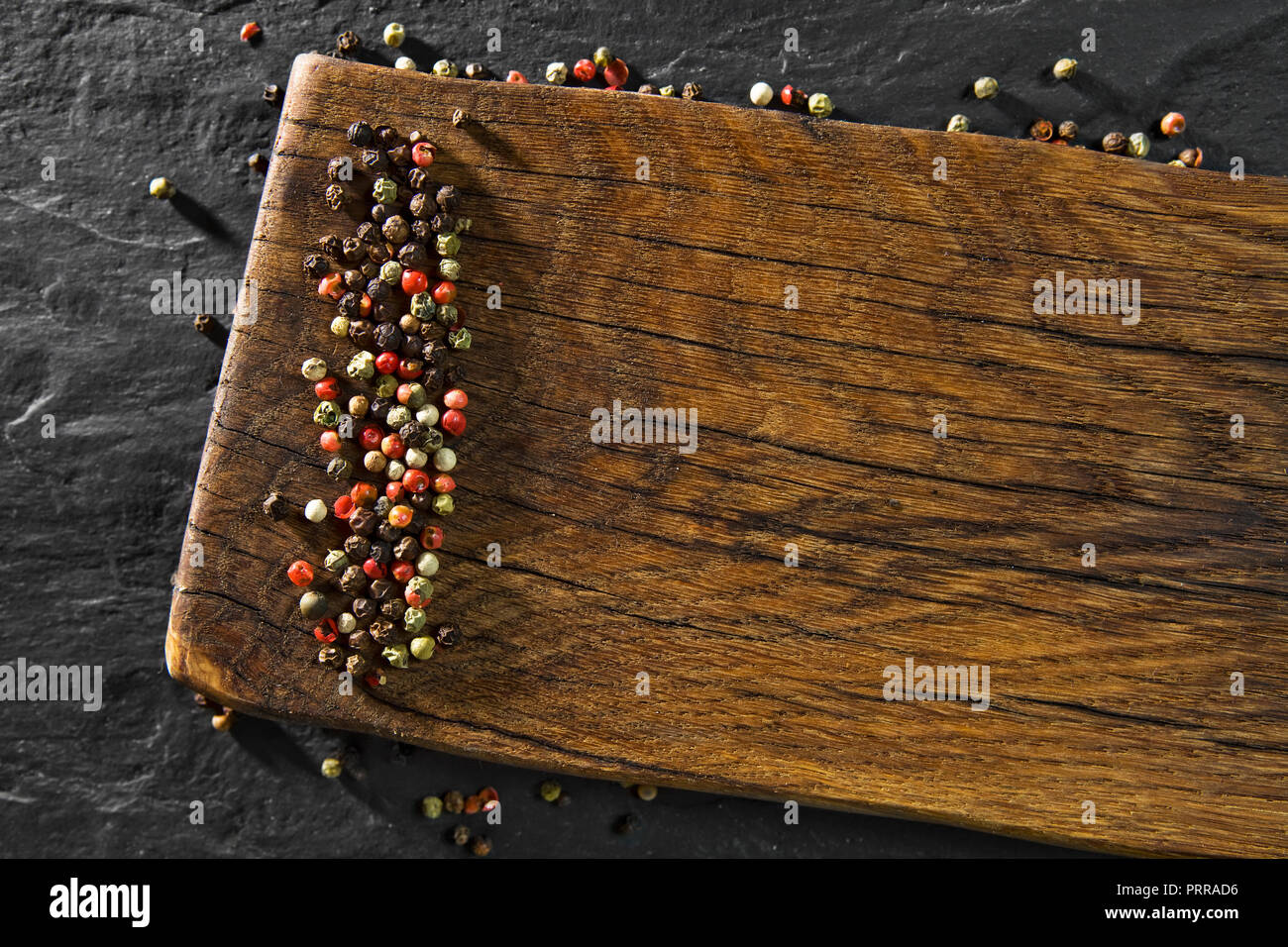 Top view of colour pepper on wooden desk and black table background ...
