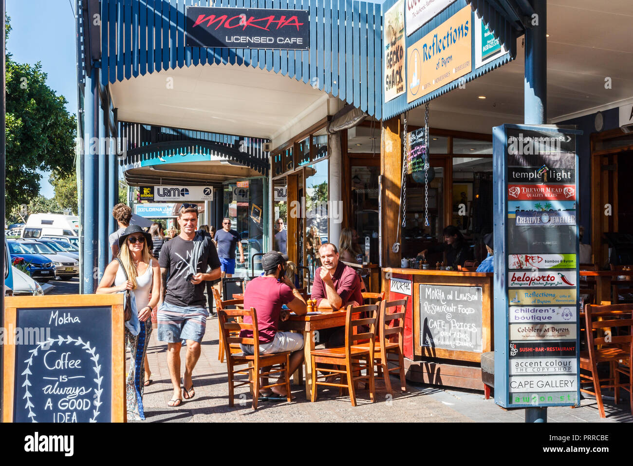 Byron Bay, Australia - 14th May 2015: People walking past and sitting ...