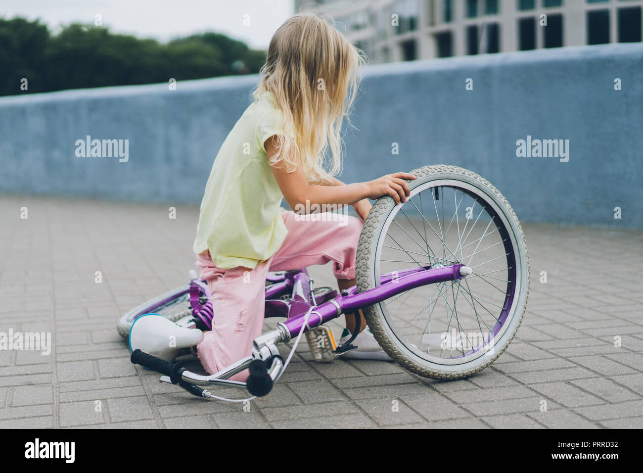 side view of little child fallen from bicycle on road on street Stock ...