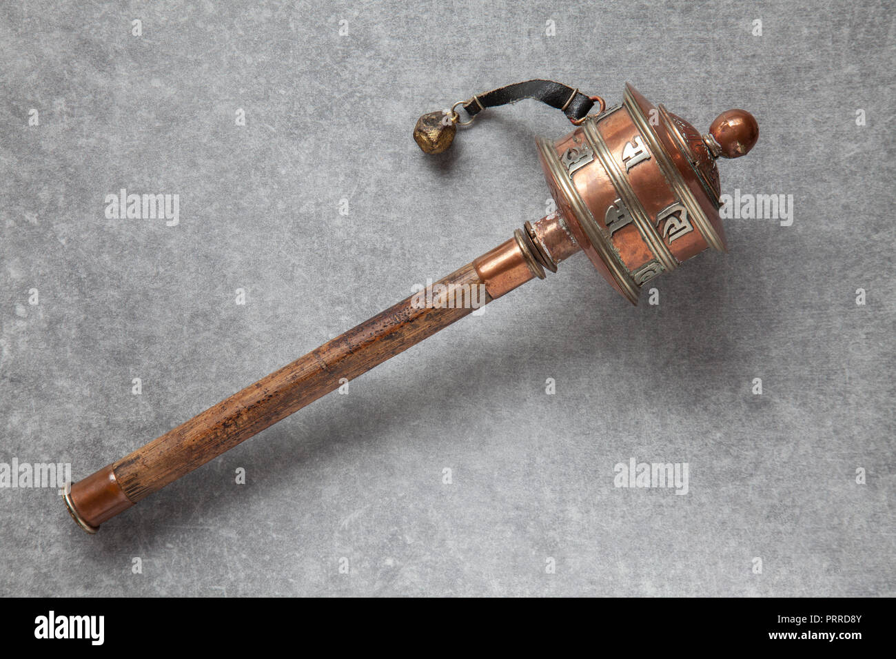 A Tibetan Buddhist Mani wheel, often called a hand prayer wheel, which ...
