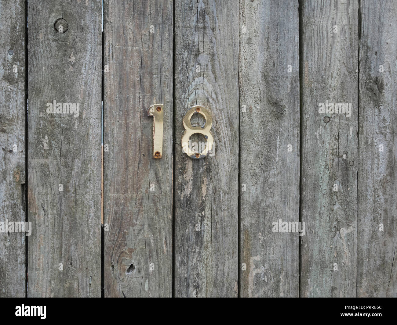 Brass Number 18 characters on a gate. Even number Stock Photo - Alamy