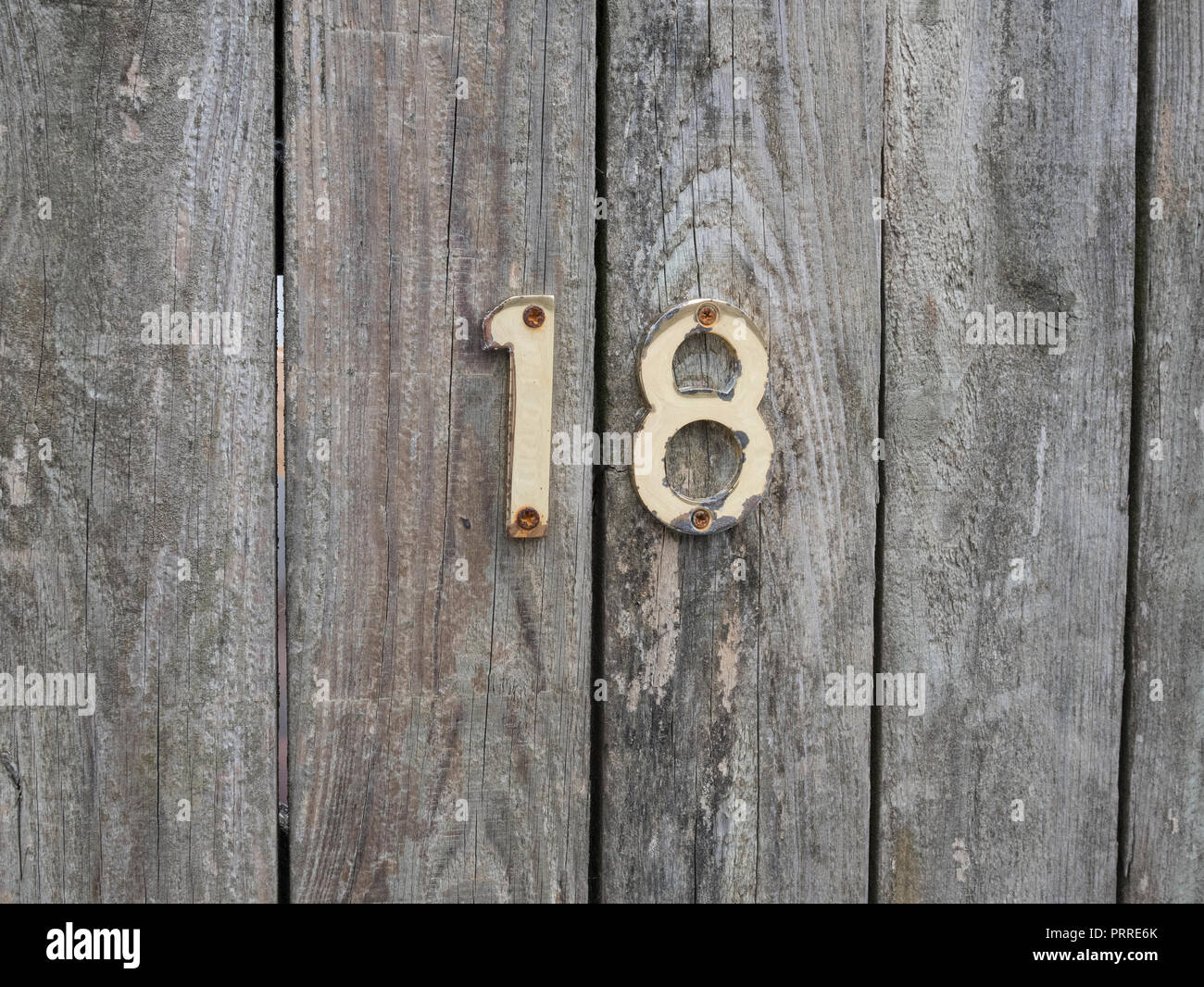Brass Number 18 characters on a gate. Even number Stock Photo - Alamy
