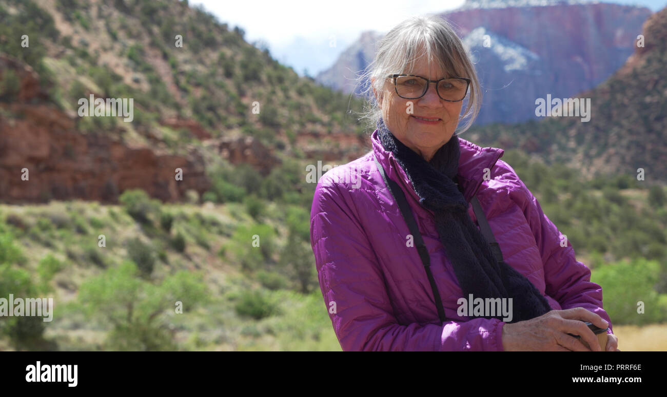 Closeup view of charming elder female enjoying nature and smiling for ...
